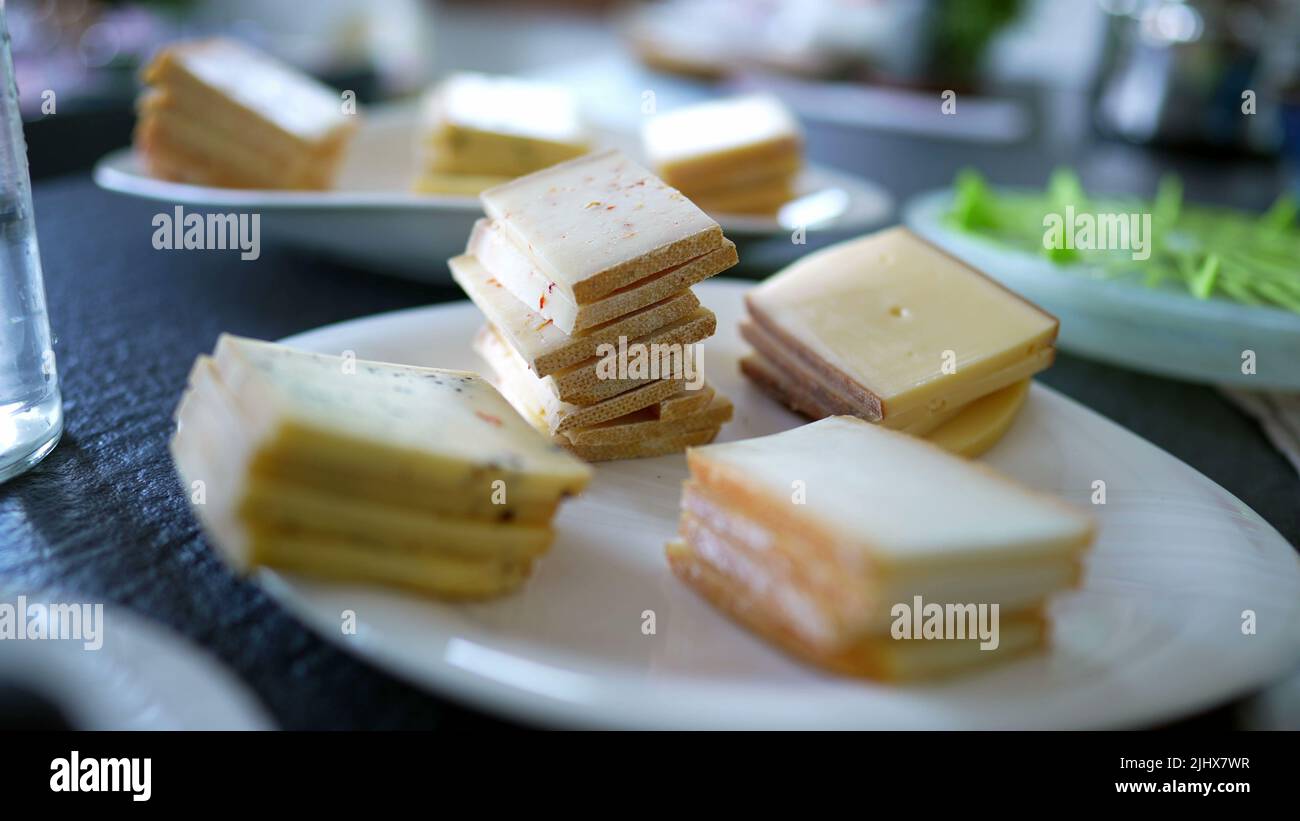 Slices of cheese on plate, traditional swiss raclette pieces Stock ...