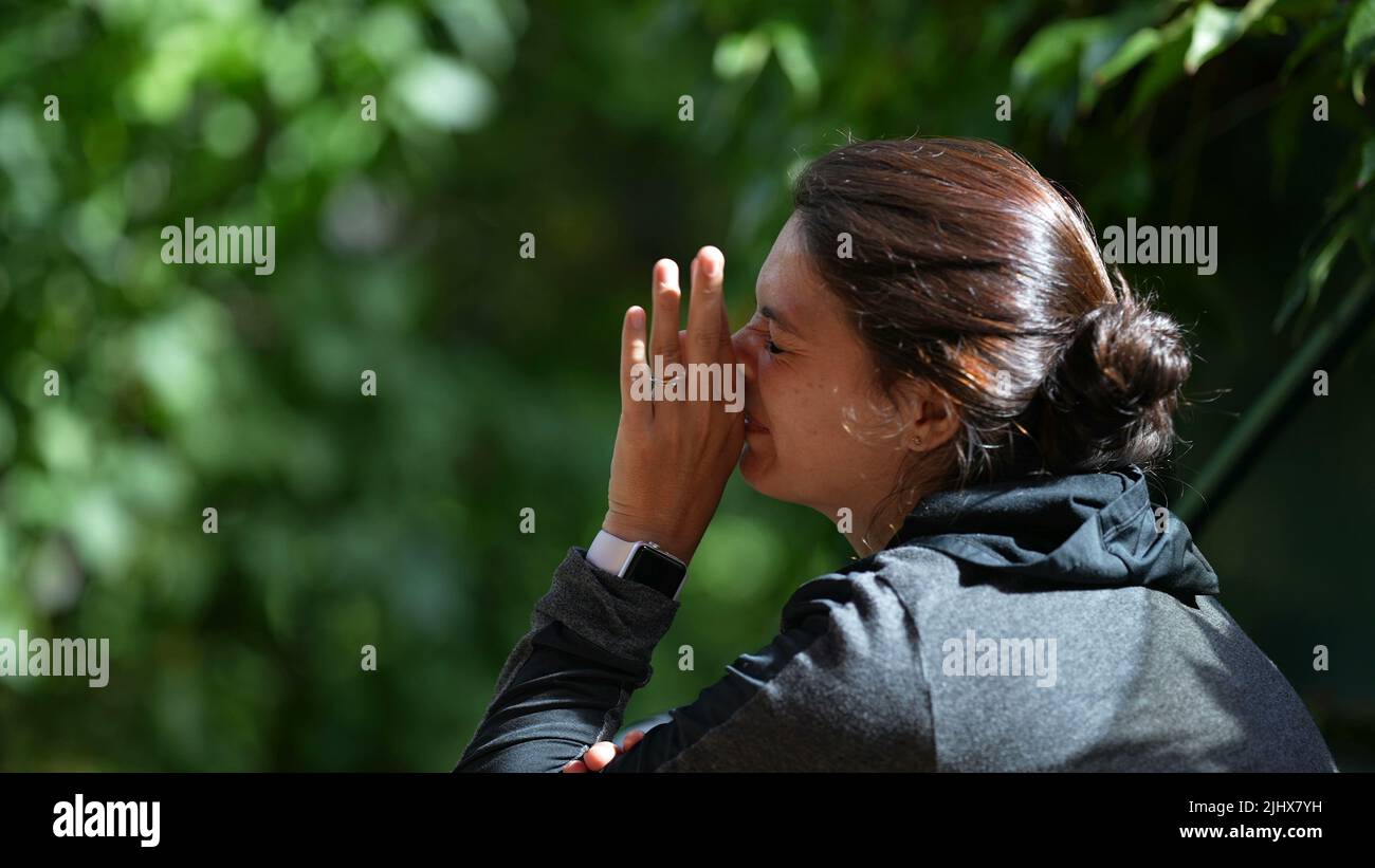 Woman rubbing nose. girl scratching face with hand Stock Photo - Alamy