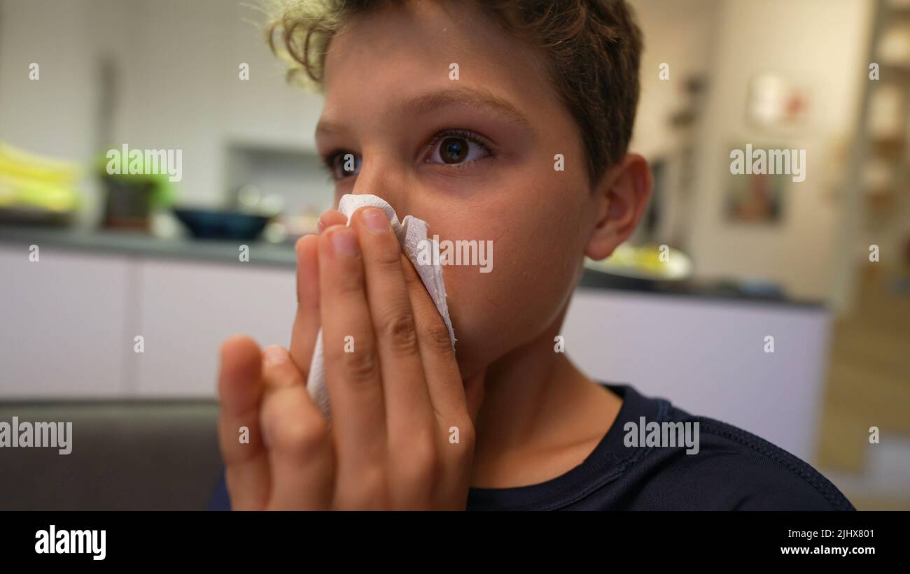 Young boy blowing nose with napkin, child nose blowing Stock Photo - Alamy