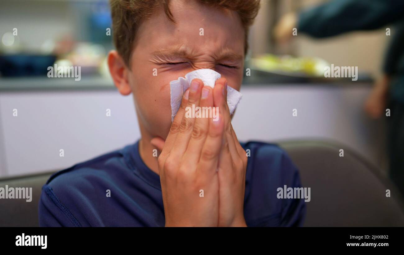 Young boy blowing nose with napkin, child nose blowing Stock Photo - Alamy