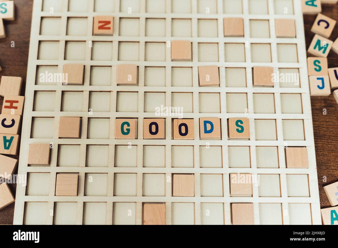 goods word made of wooden letter cubes on vocabulary game grid - stock ...