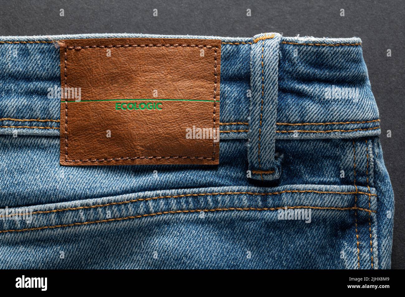 Ecological blue jeans on dark background. Eco friendly clothing concept ...