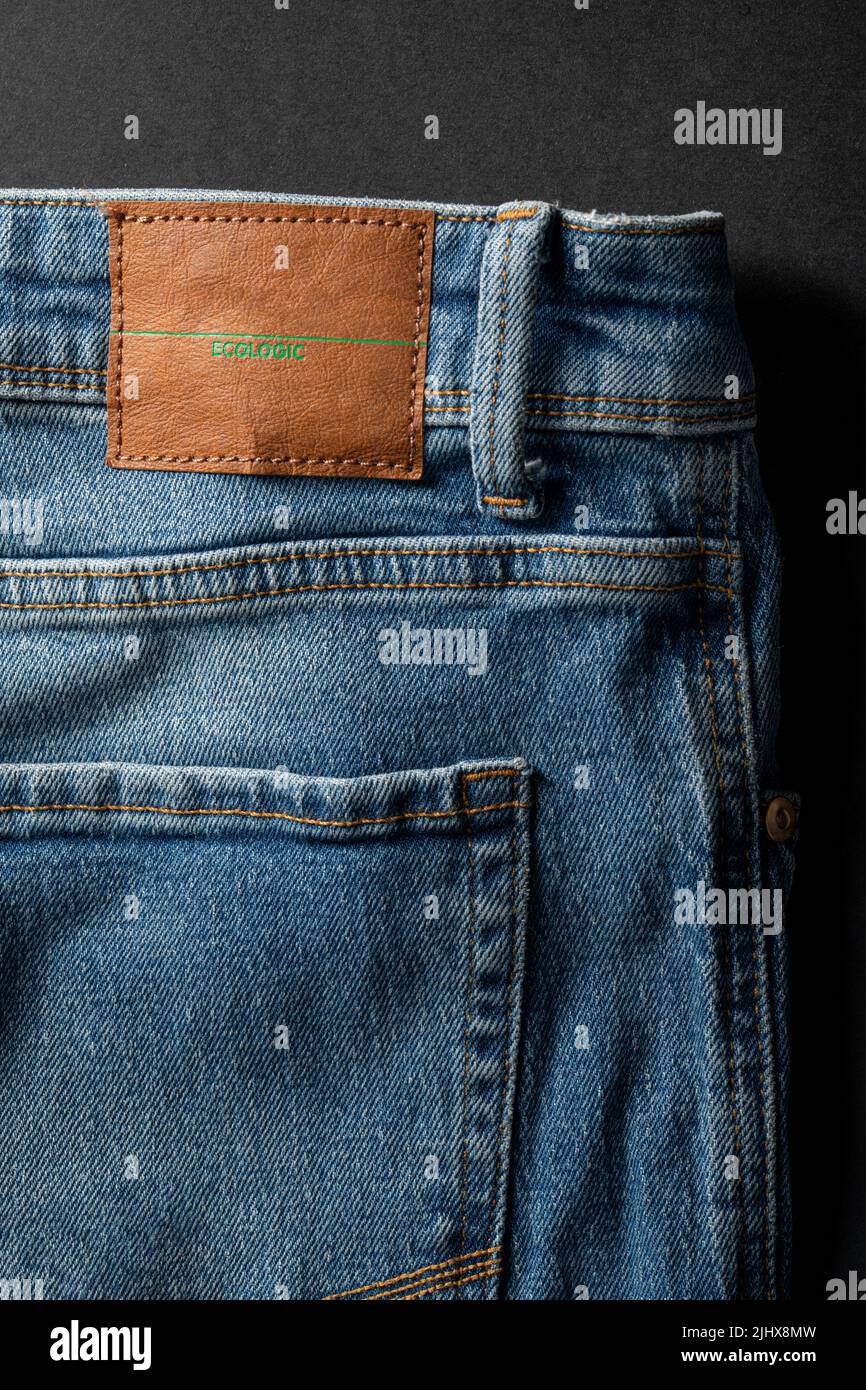 Ecological blue jeans on dark background. Eco friendly clothing concept ...
