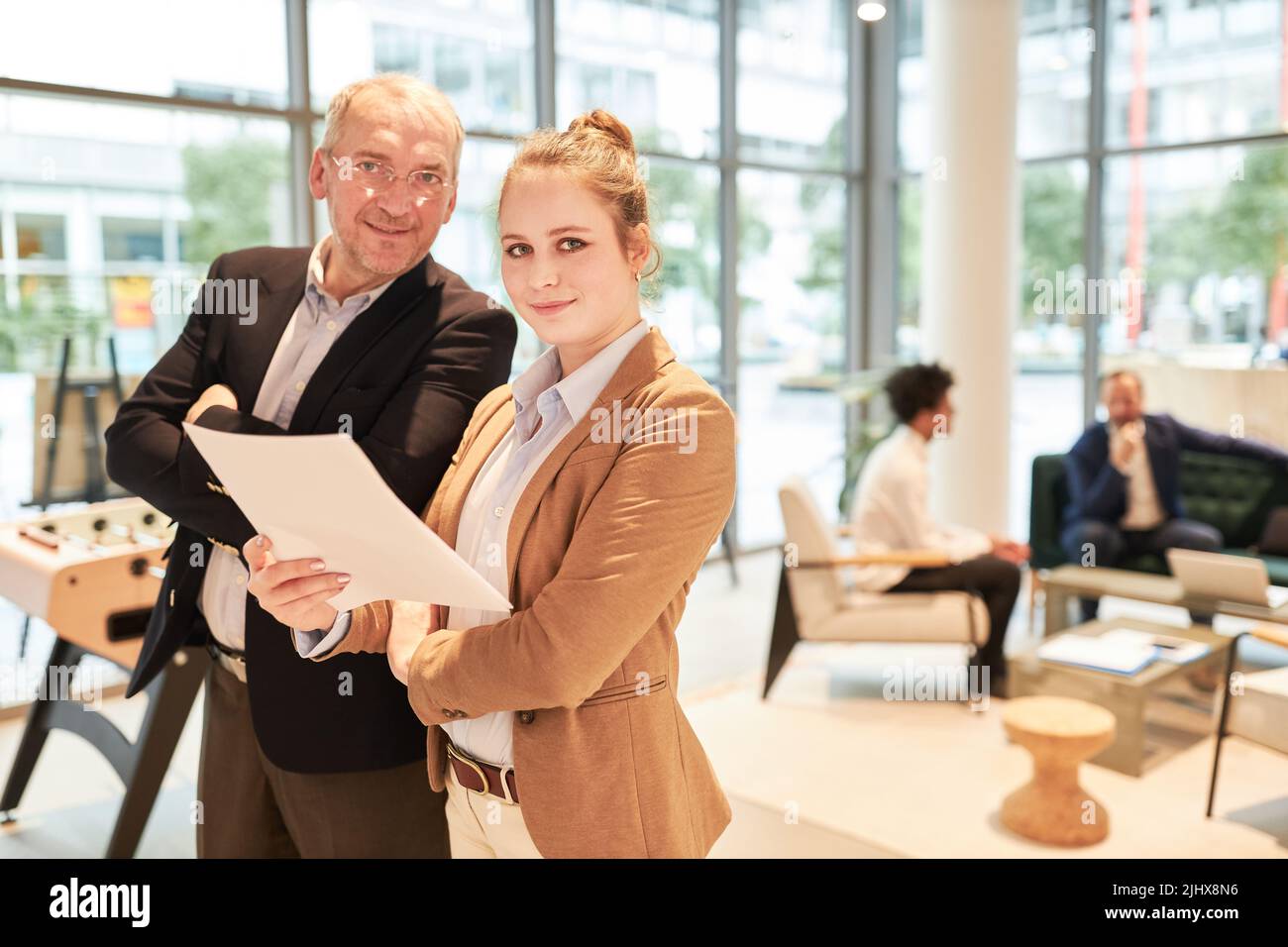 Older business man as a successful consultant and young colleague as a ...