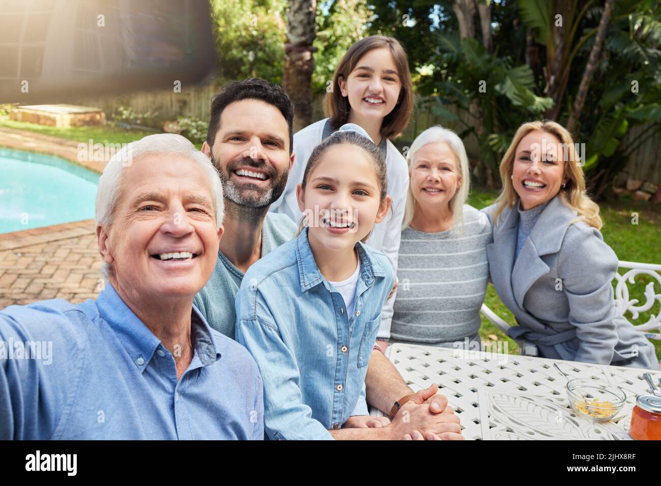 A hug from family lasts a lifetime. a multi-generational family posing ...
