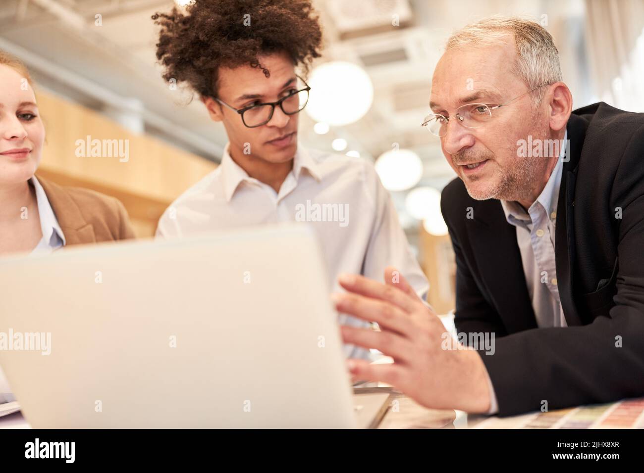 Consulting man at the laptop computer giving strategy advice to the ...