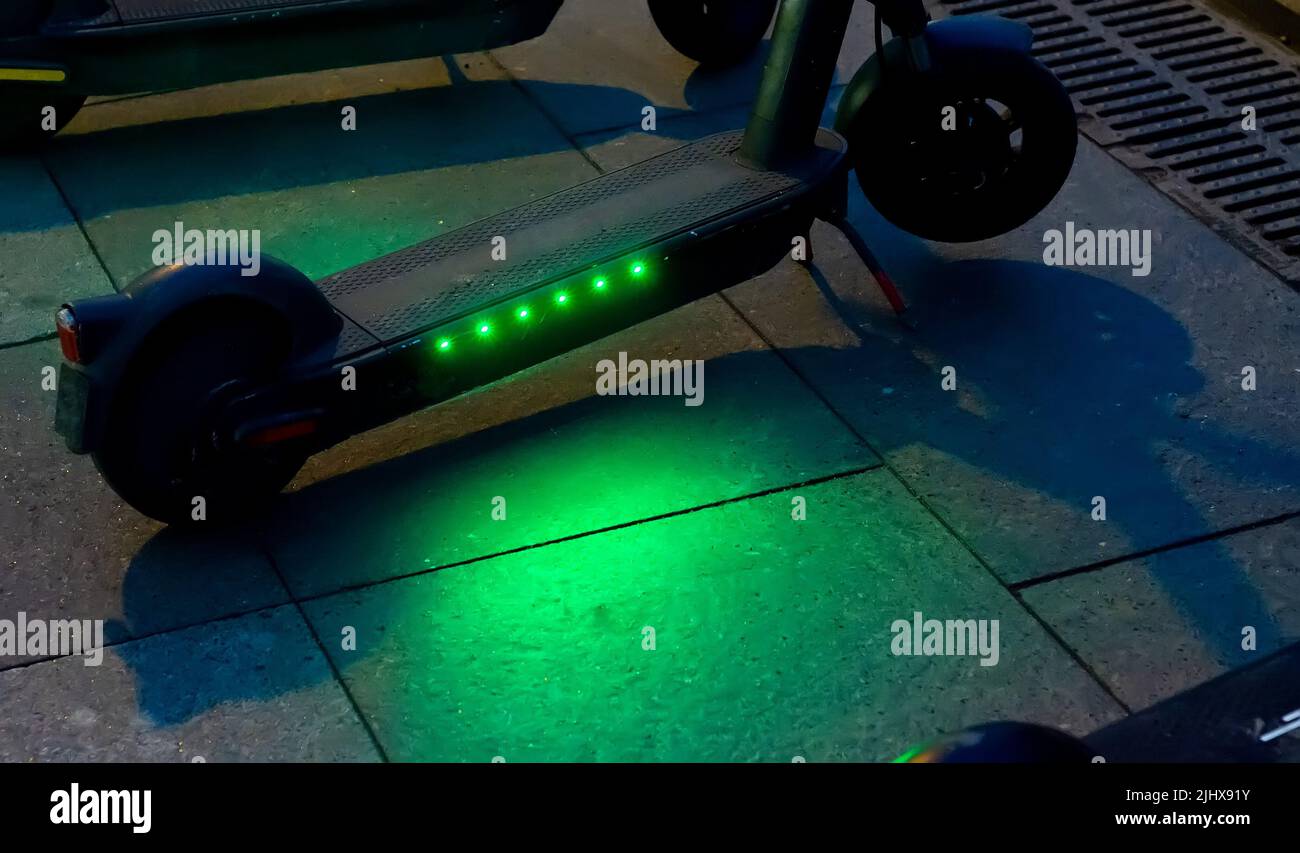 electric scooter in night street.Green neon lights Stock Photo - Alamy