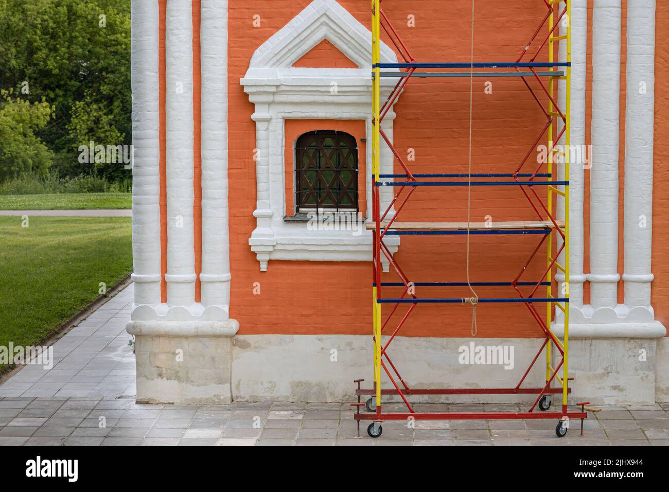 a mobile staircase stands near the building during restoration. High ...