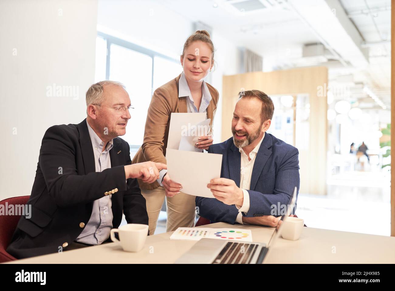 Manager and a colleague are happy about a positive annual report or a ...