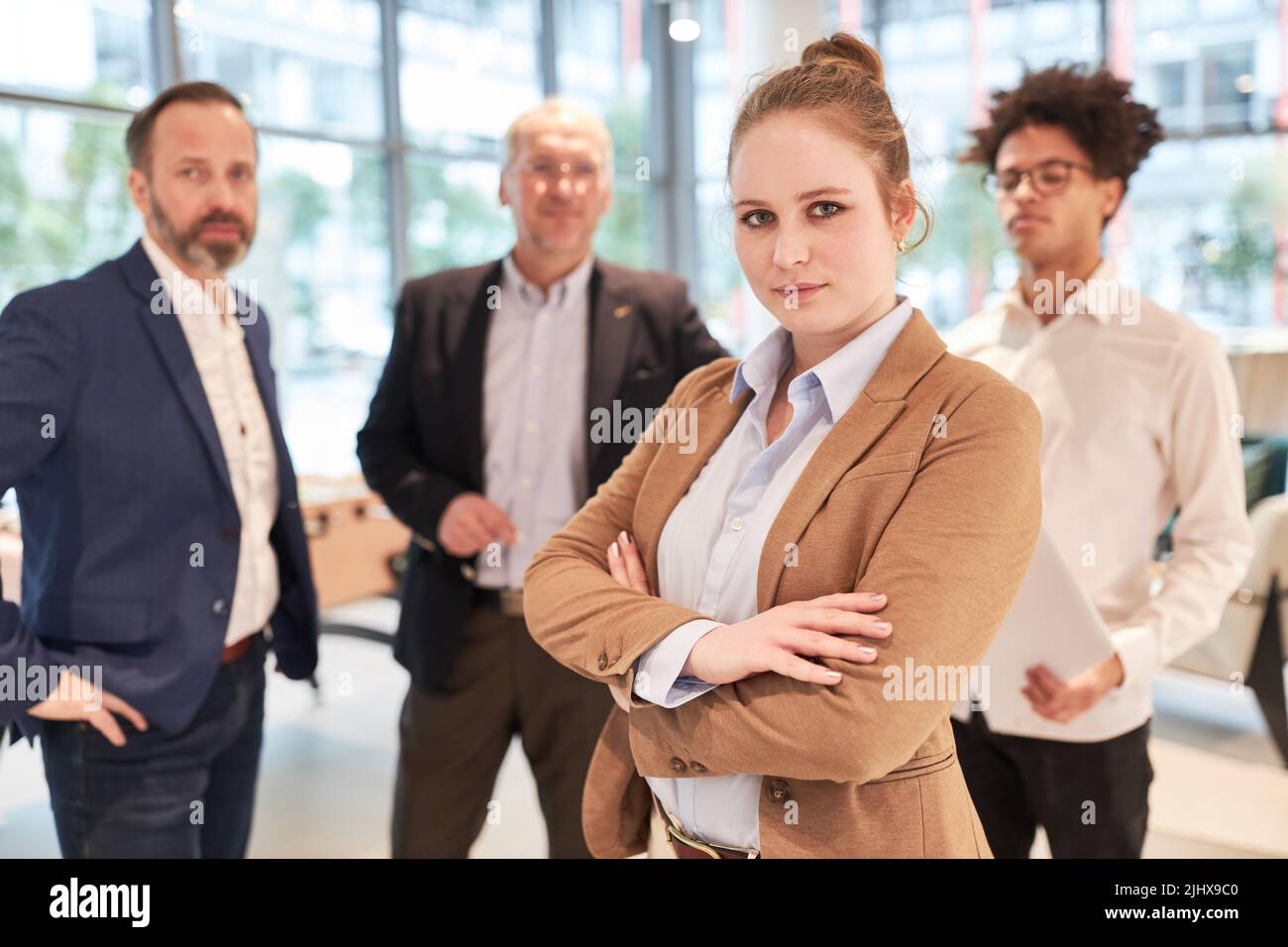 Confident business woman as boss and startup founder with her team in ...