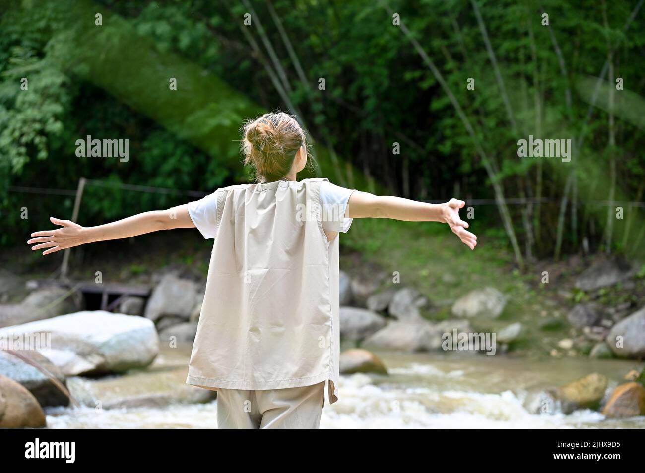Beautiful and relaxed young Asian female traveler standing with ...
