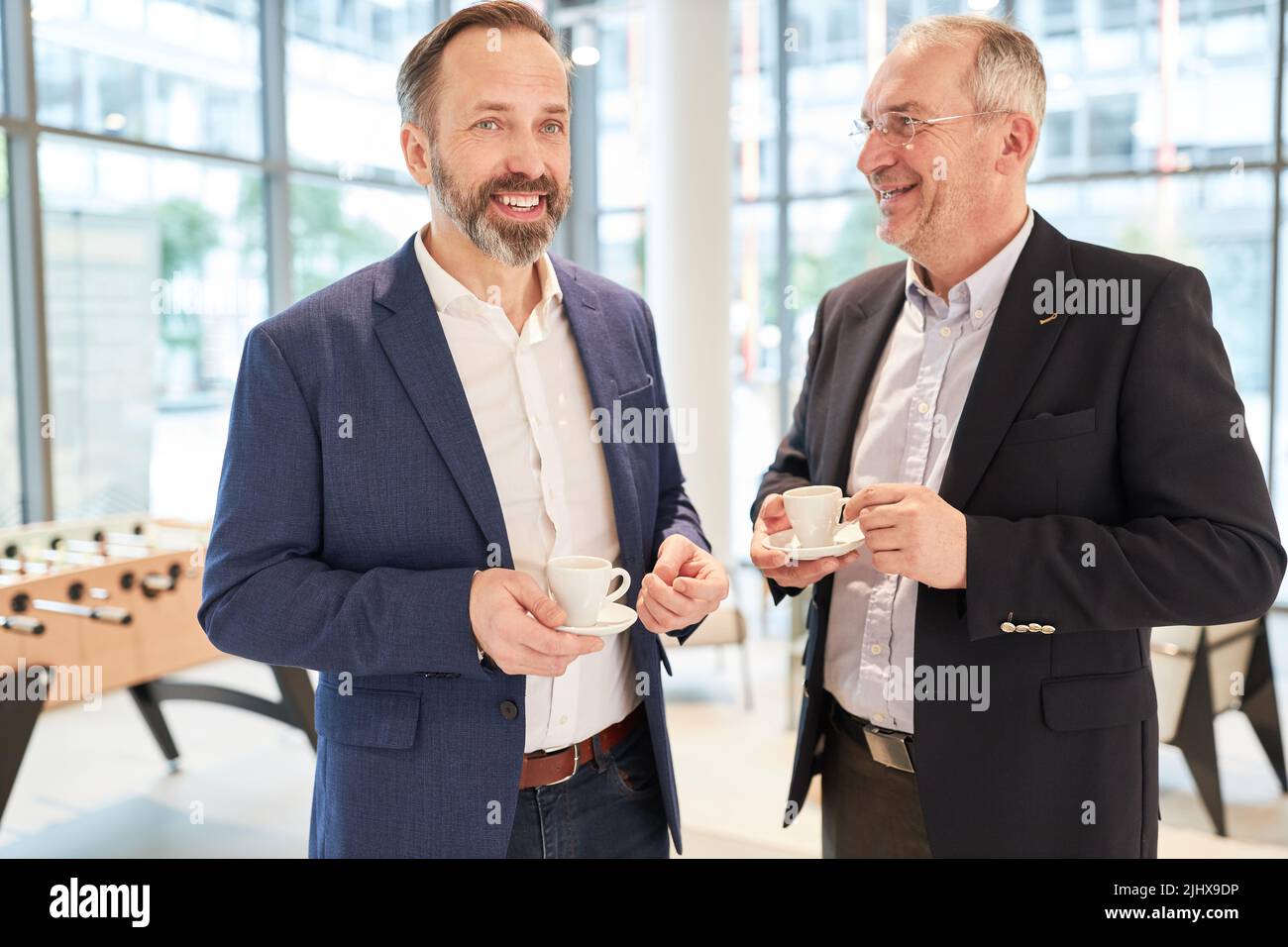 Two business people talk in hi-res stock photography and images - Alamy