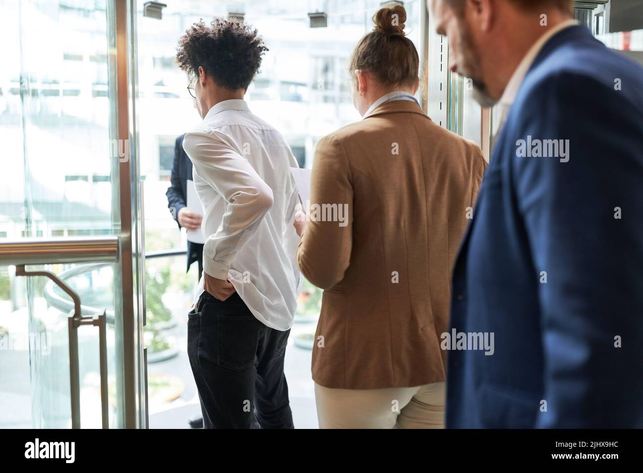 Group of business people having a break at the window in the office ...