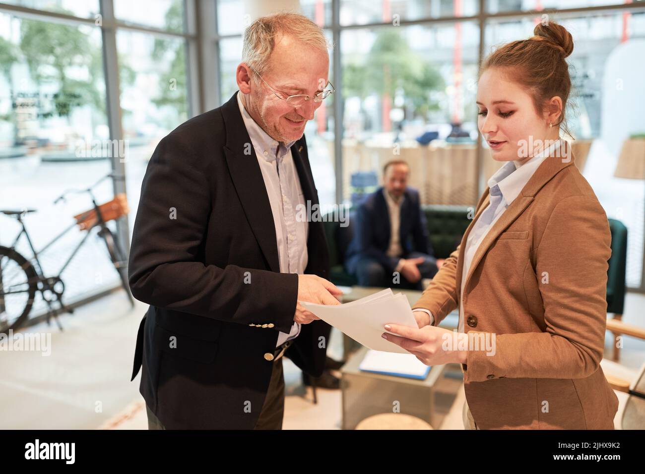 Senior manager and young businesswoman discussing project planning and ...