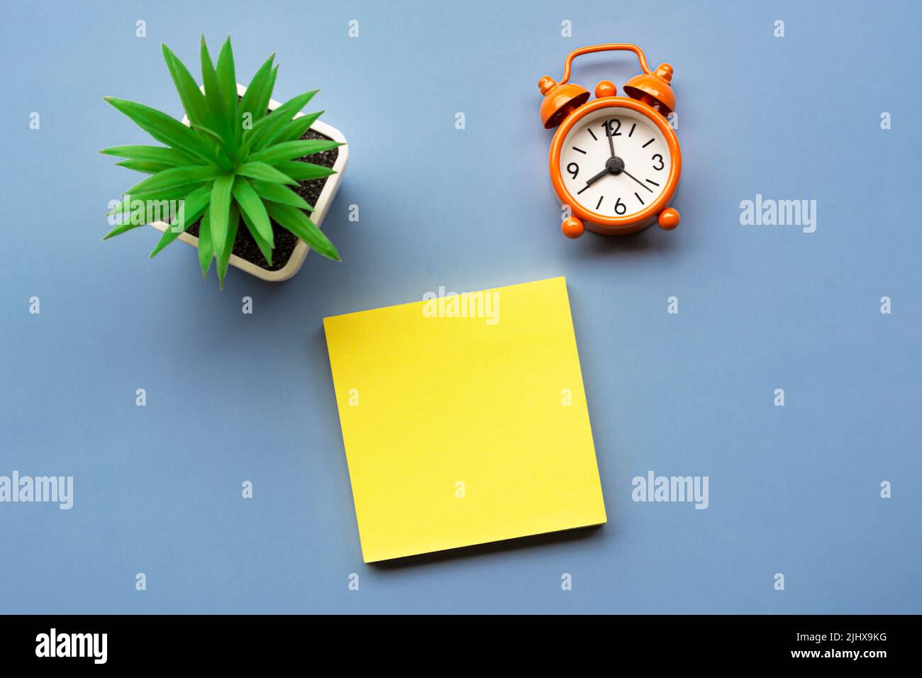 Adhesive Note with potted plant and alarm clock set at 8 o'clock. Copy ...