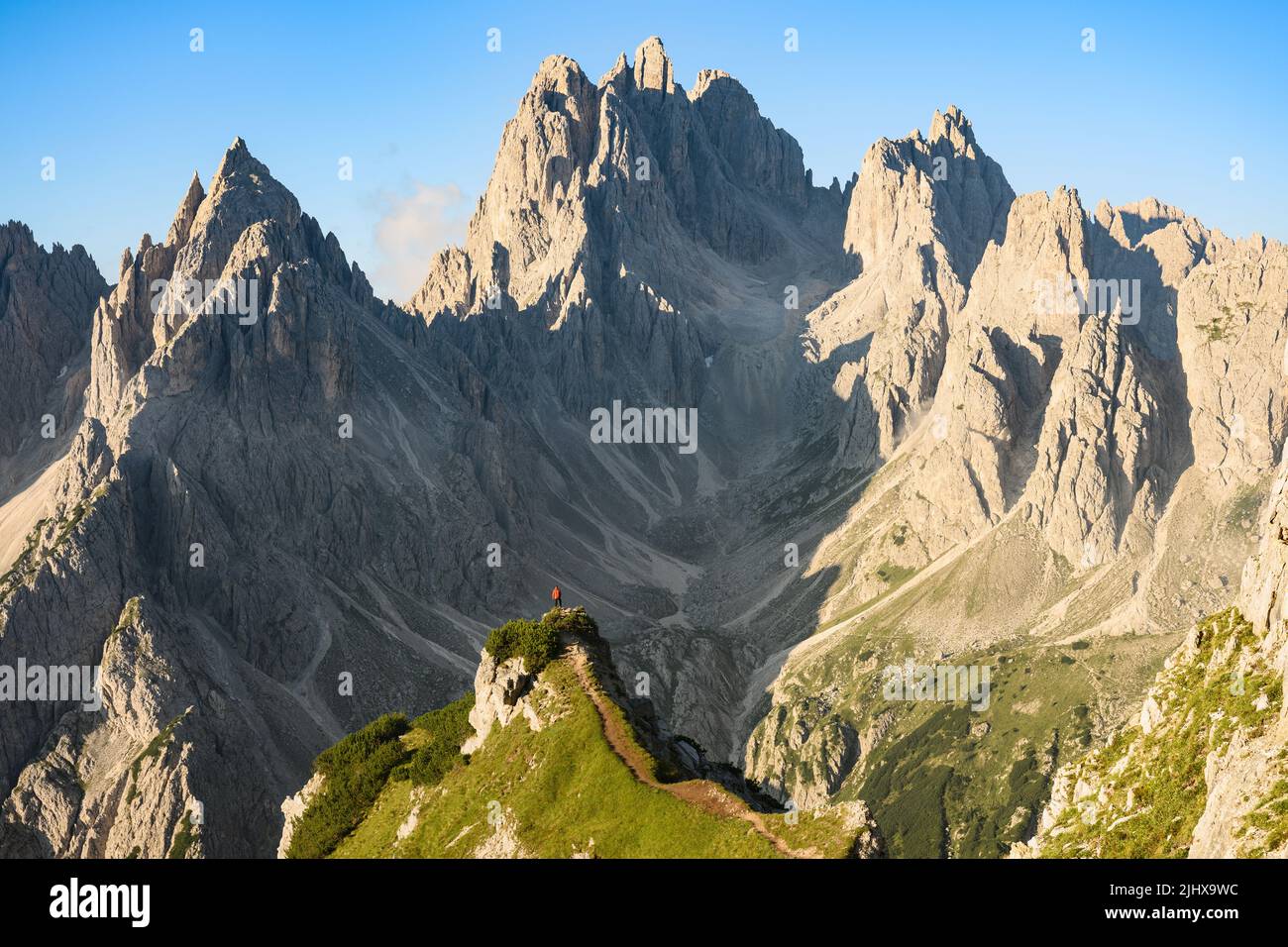 Stunning view of a tourist on the top of a hill enjoying the view of ...