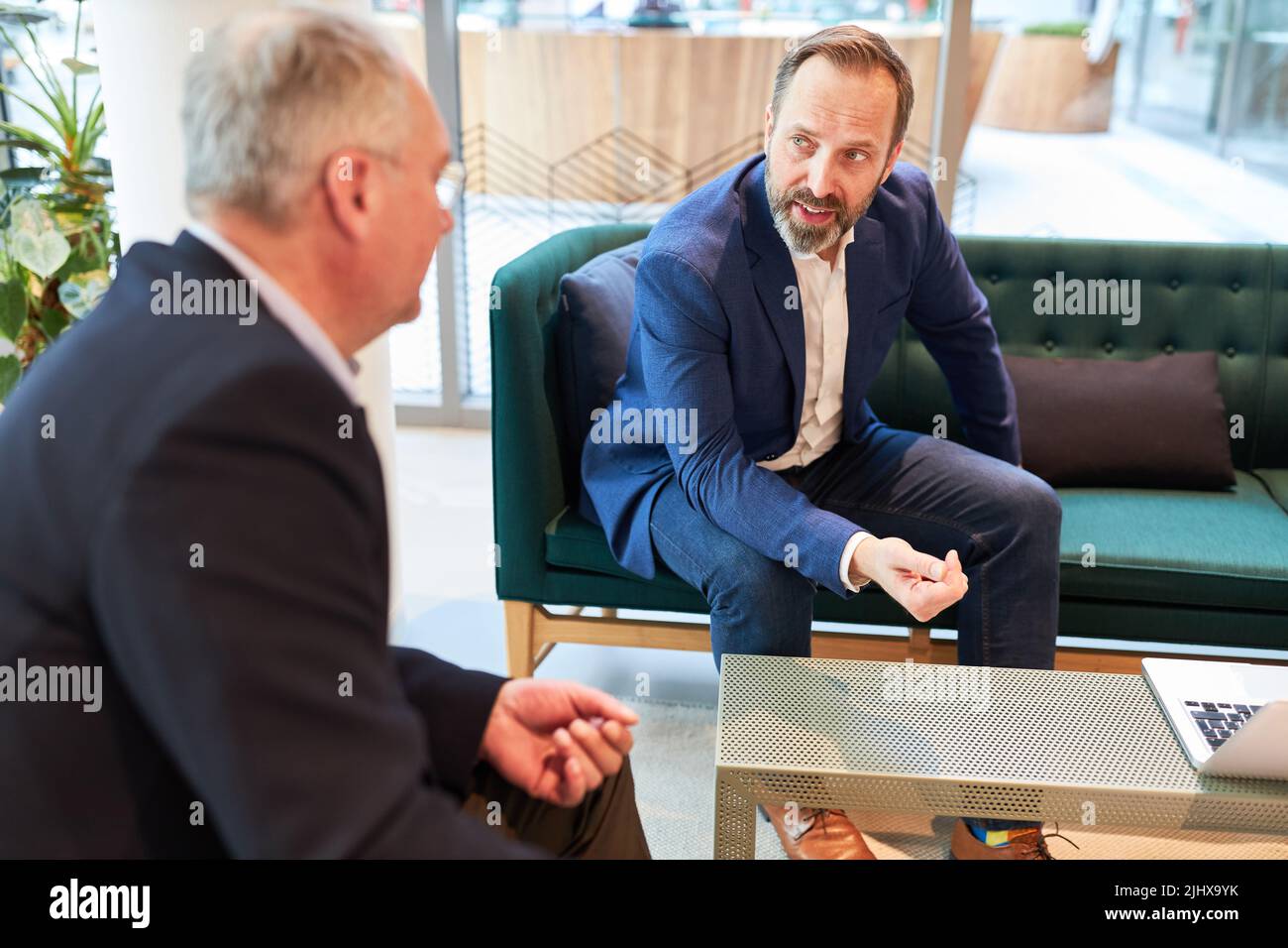 Two business people as business partners in a negotiation or discussion ...