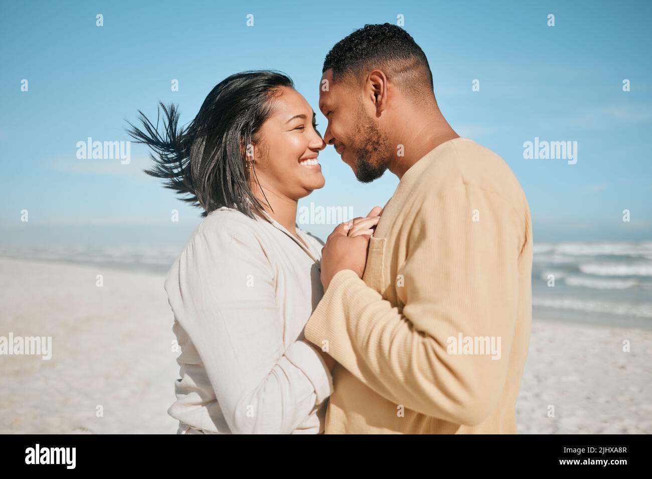 Loving young mixed race couple touching noses while dancing on the ...