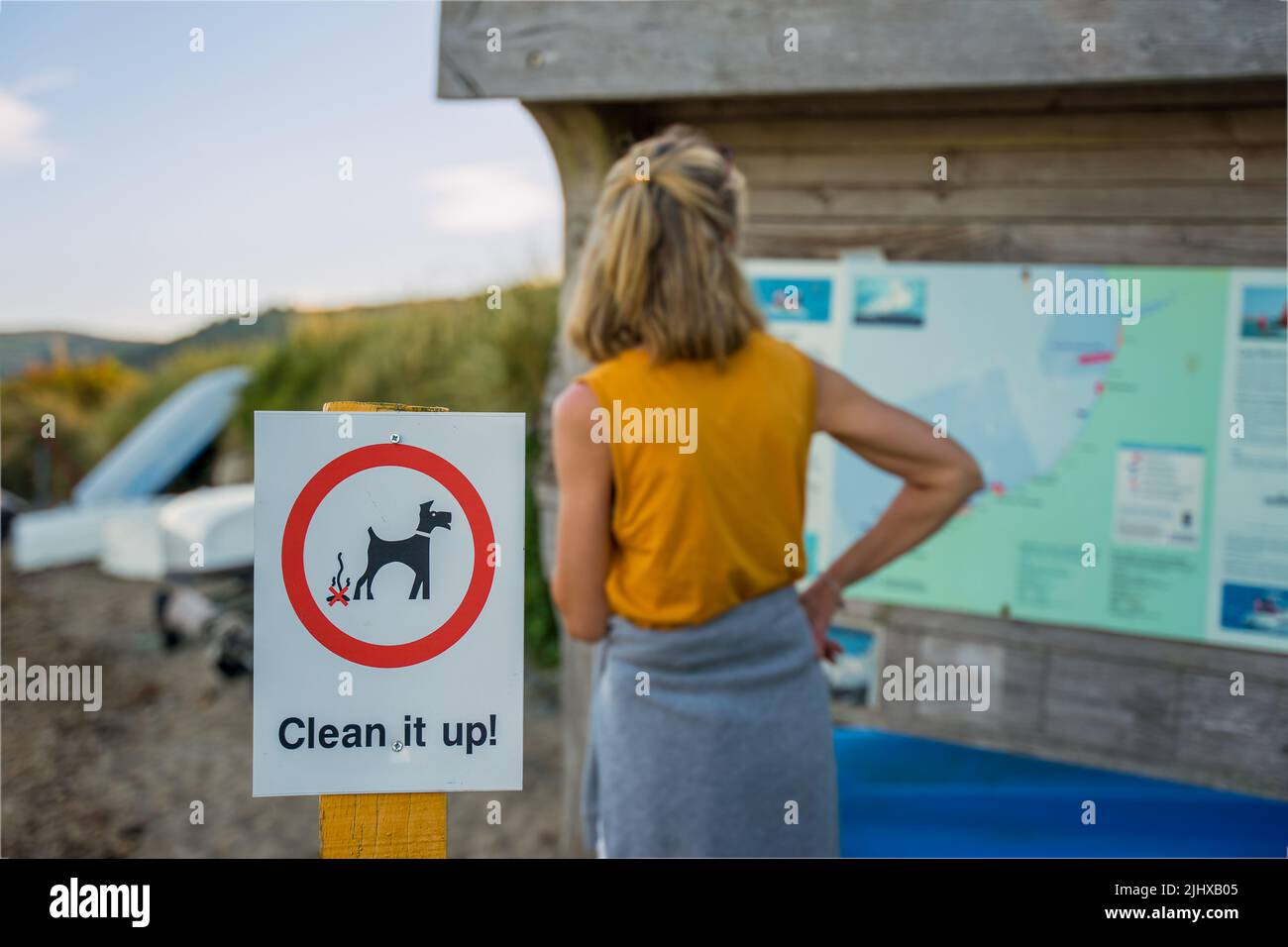 selected focus of notice sign for dog owners to clean up dog poo ...