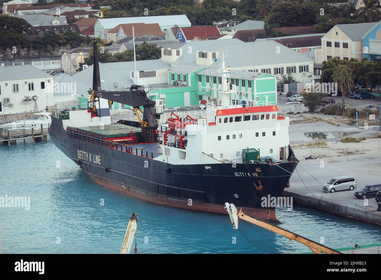 cargo container ship and small cargo ship sailing in still water Stock ...