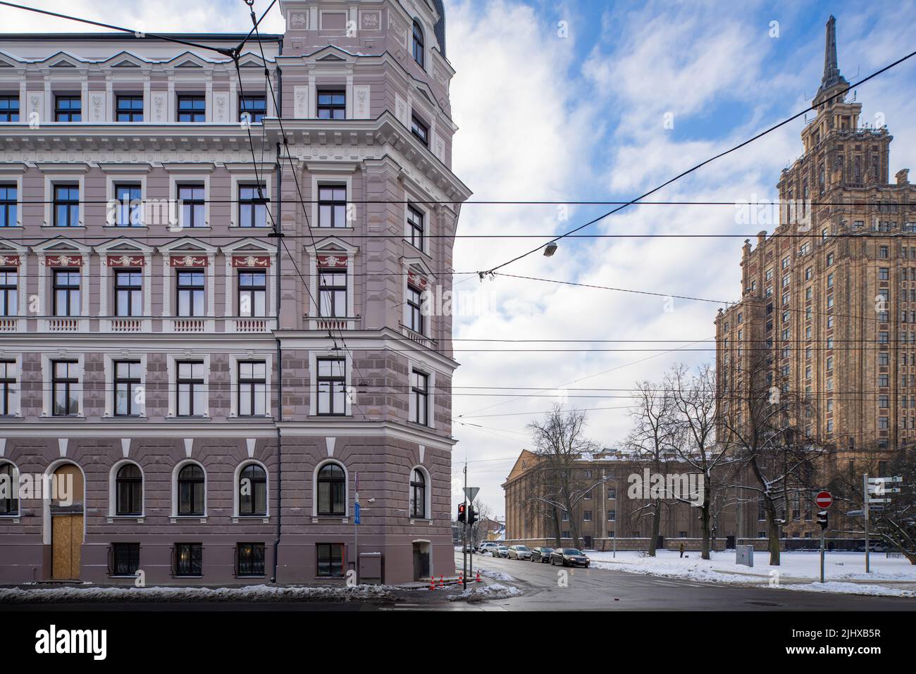 Winter cityscape of Riga. Modern architecture. Snow on road. Cloudy sky ...