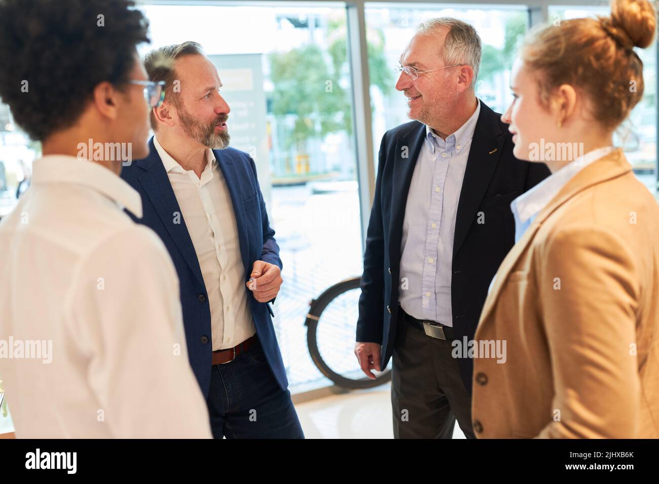 Business people as business partners or colleagues making small talk on ...