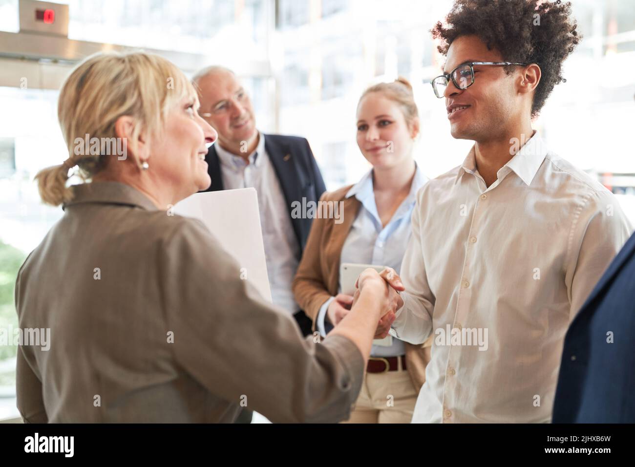 Business people shaking hands in greeting or congratulations on ...