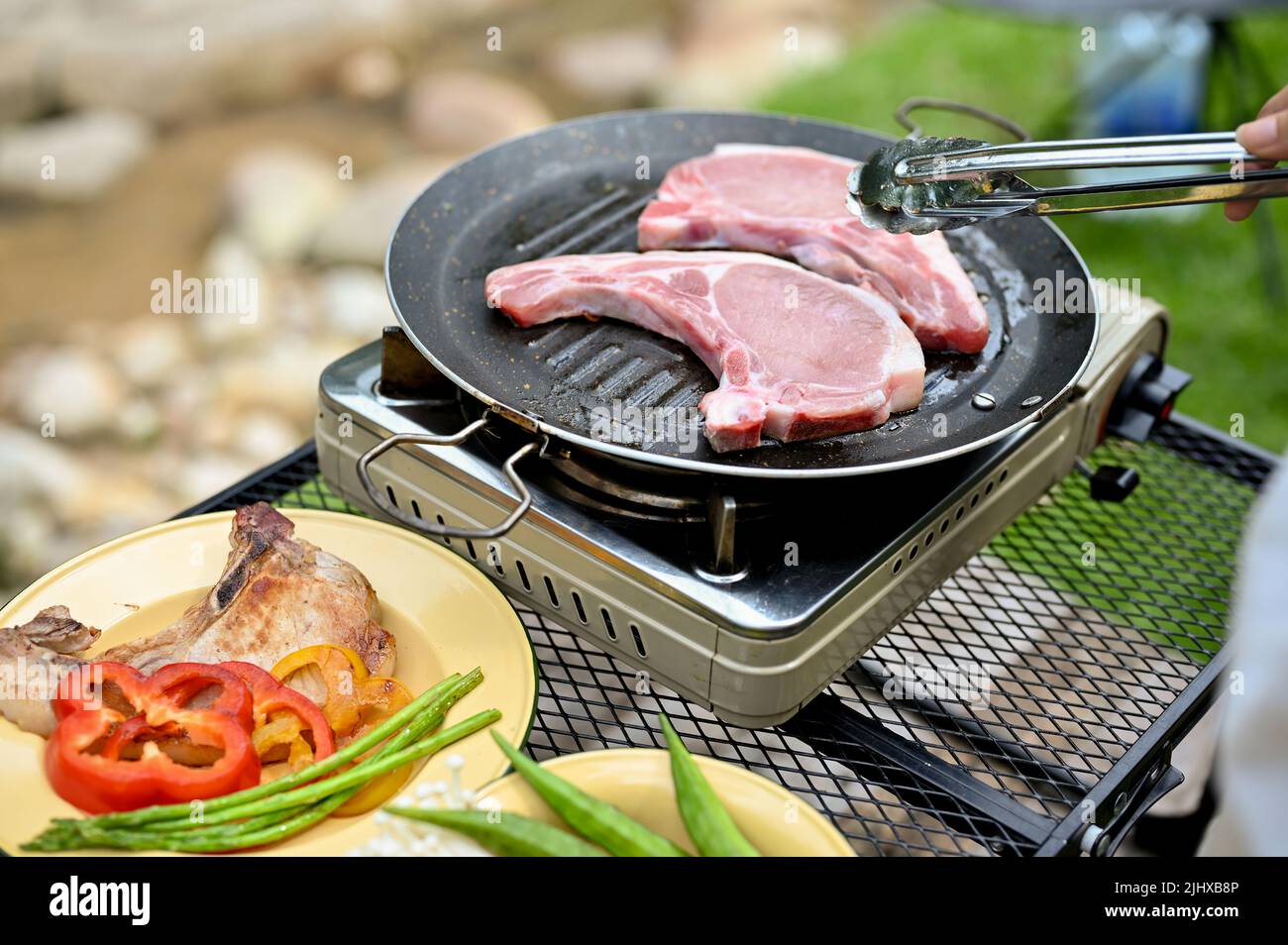 Close-up image, A raw pork chop beef steak on a flying pan, cooking ...