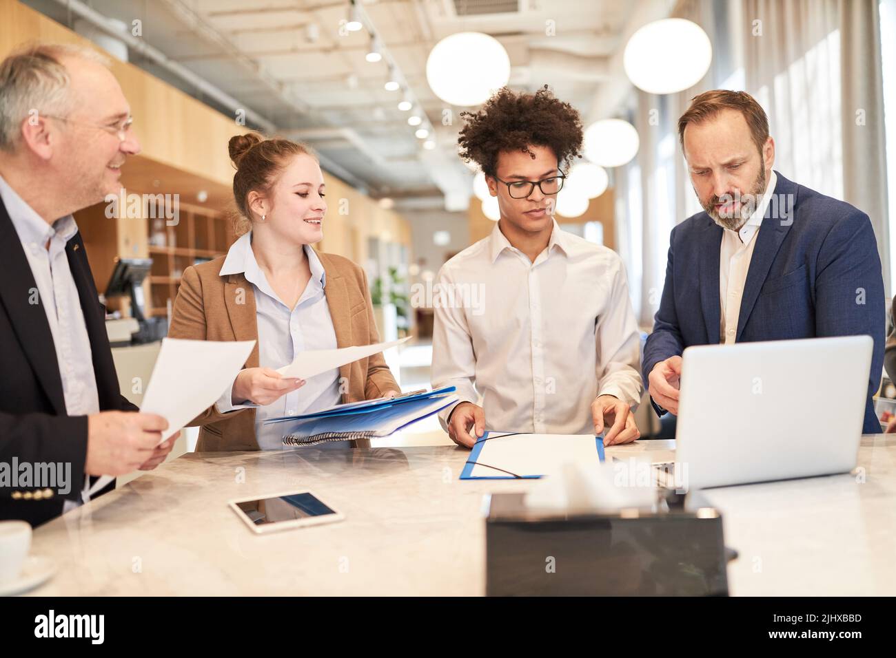 Multicultural business team planning a project on the PC in a meeting ...