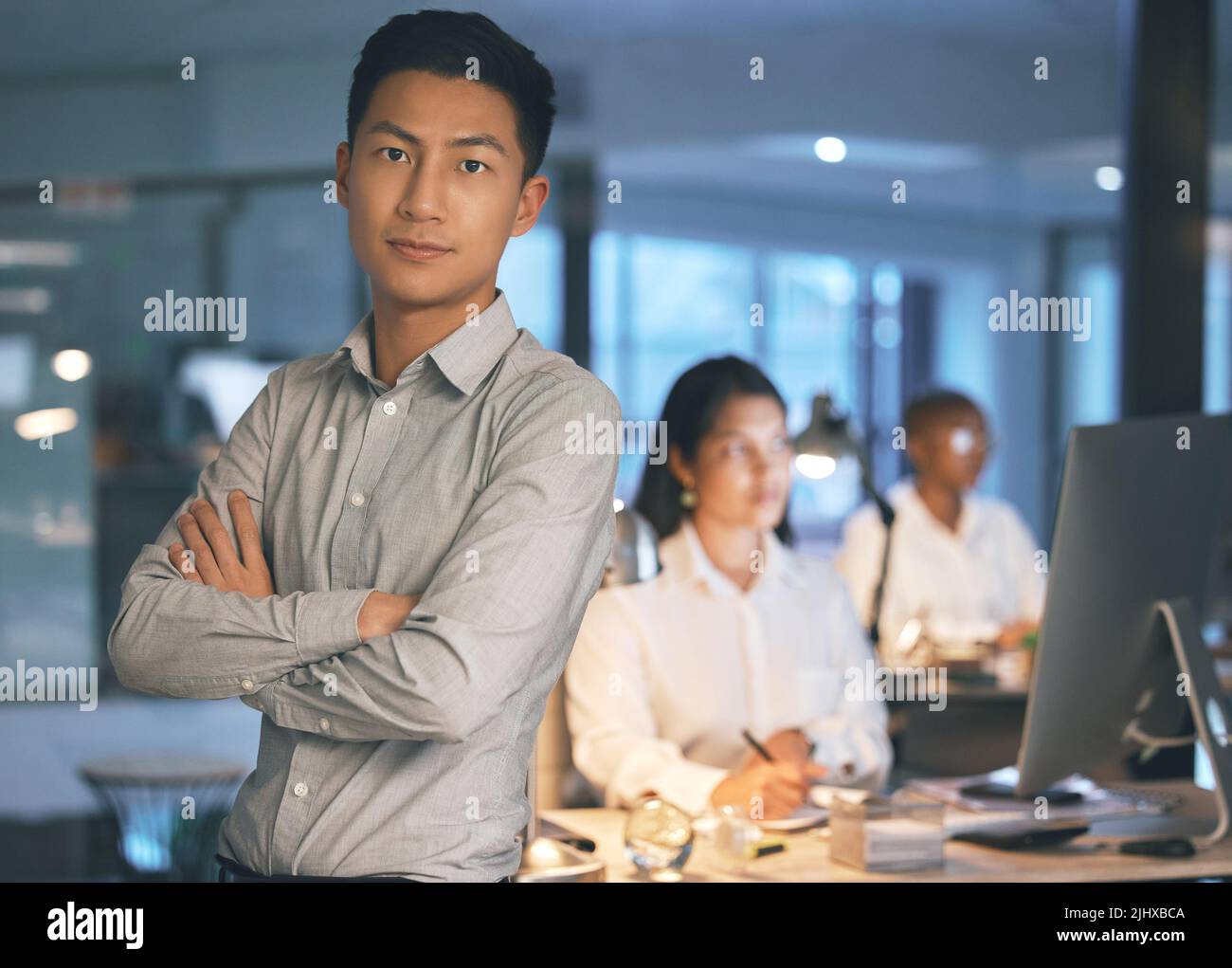 Reaching for success. a young businessman standing with his arms ...