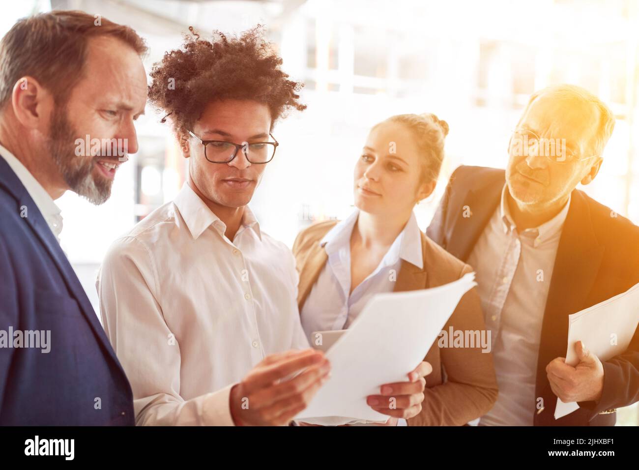 Business people in business team looks at annual report or business ...