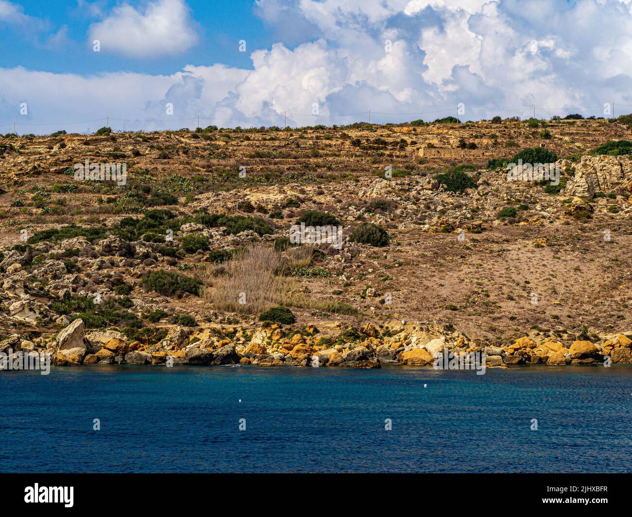 A view of a beach with dry grass on a cloudy day Stock Photo - Alamy