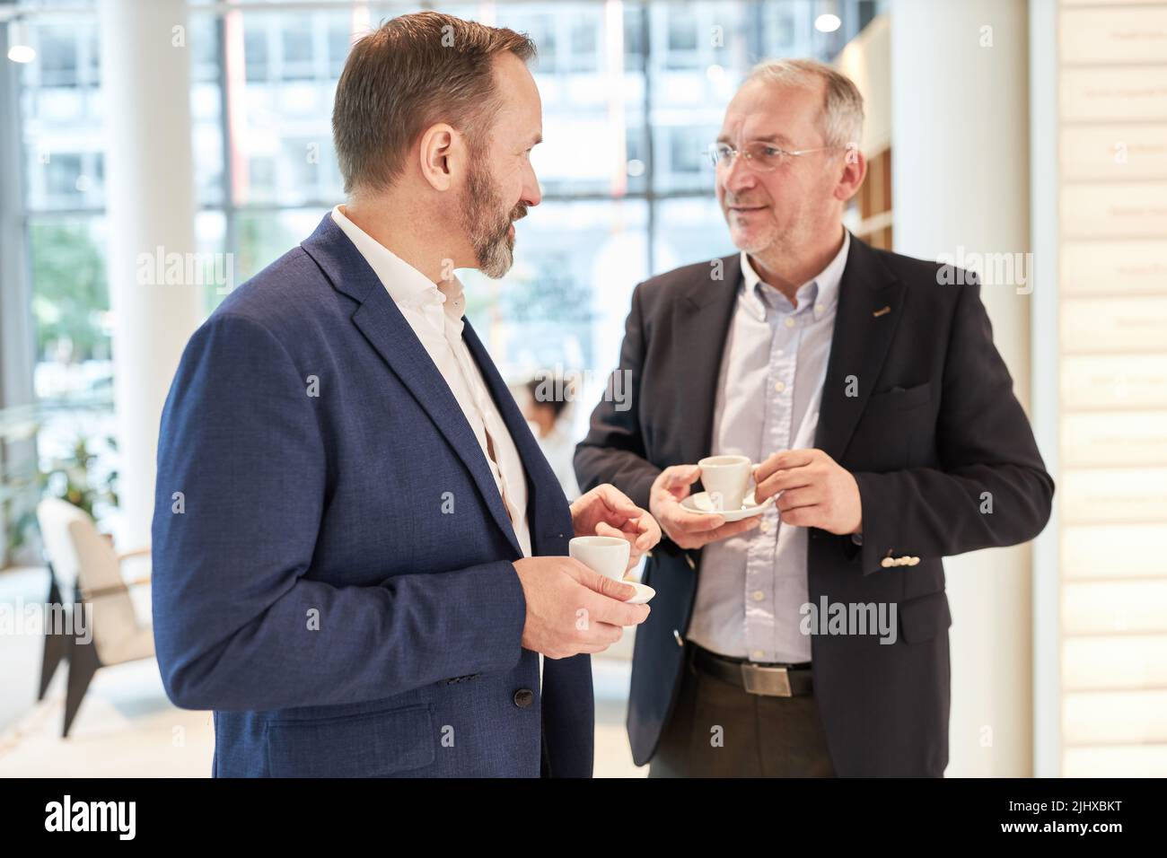 Two business people as colleagues or business partners in the coffee ...