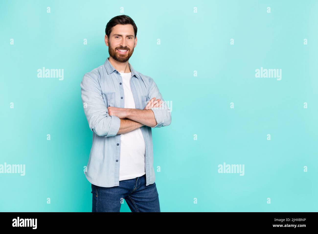 Portrait of nice positive person folded arms toothy smile empty space ...