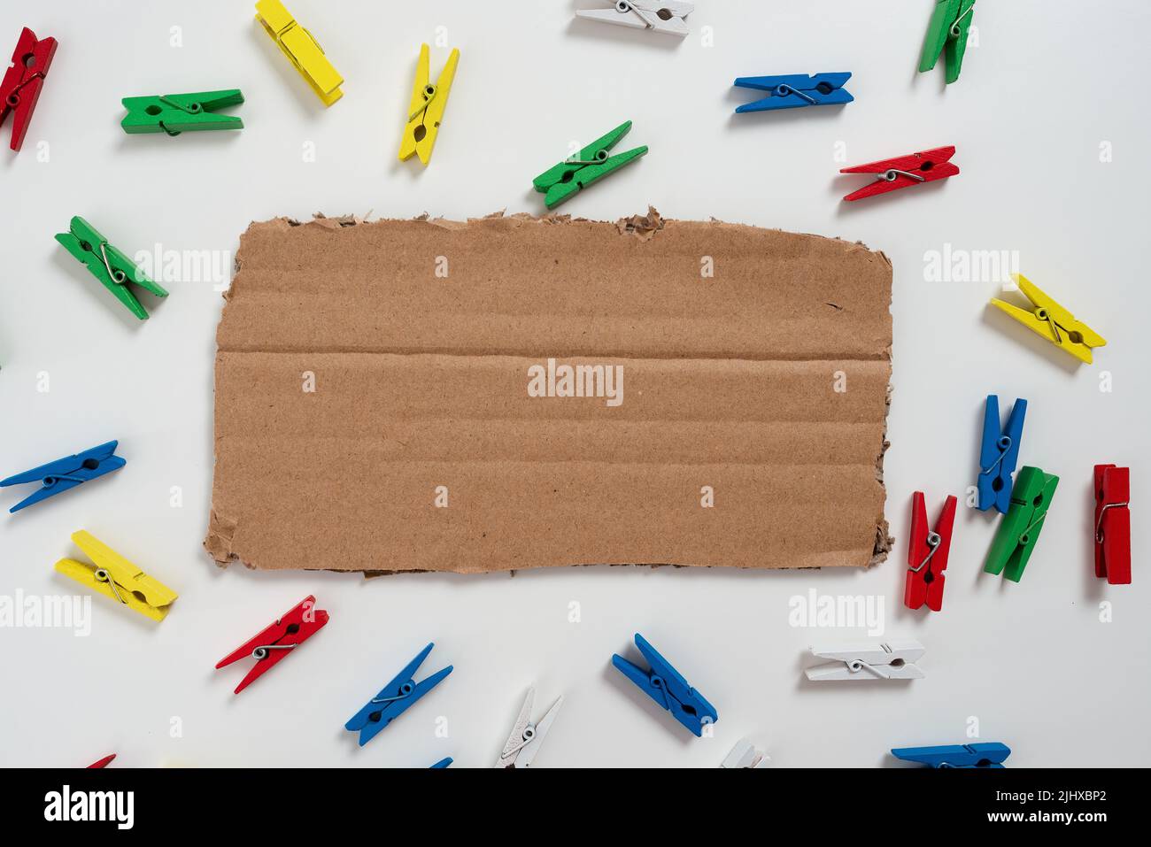 Piece Of Carboard With Important Message Surrounded By Colorful Pegs ...