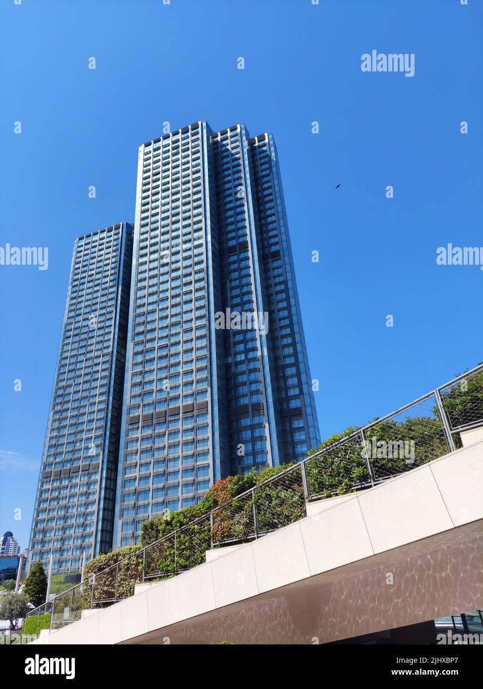 Low angle shot of the blue background of glass high-rise building ...
