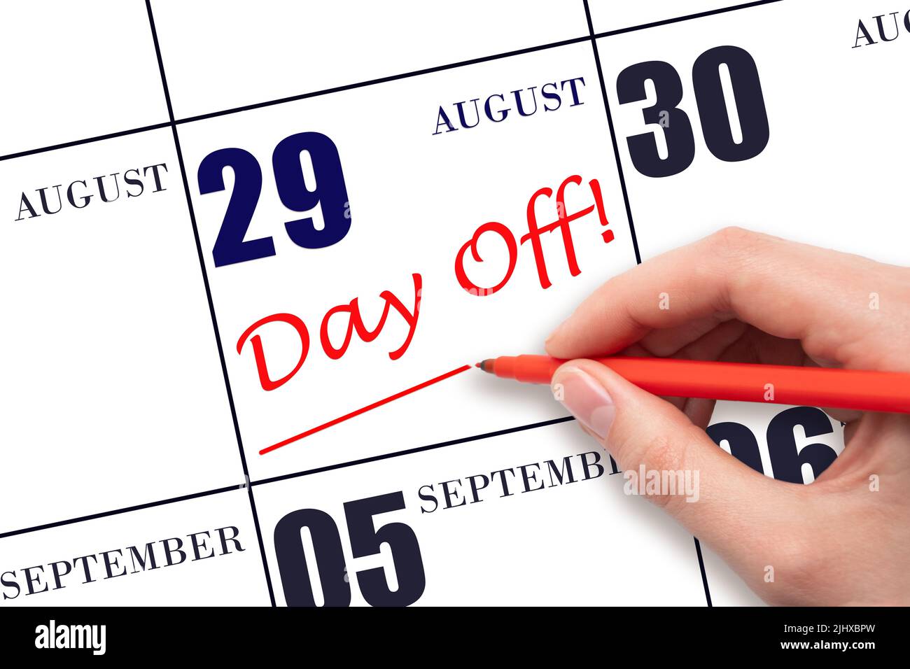 29th day of August. Hand writing text DAY OFF and drawing a line on ...
