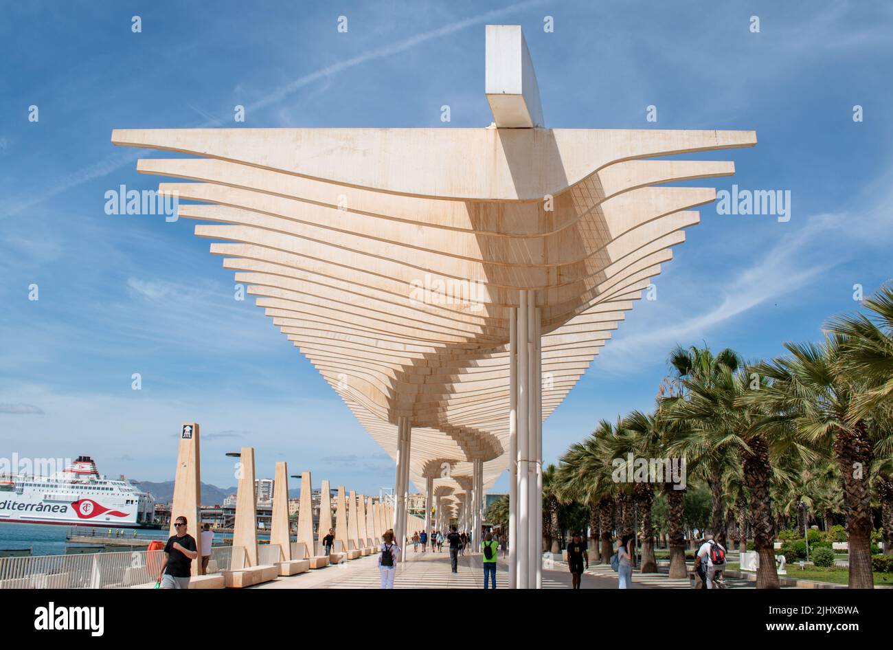 Architecture of Muelle Uno in Malaga. Tourists fill this busy scene and ...