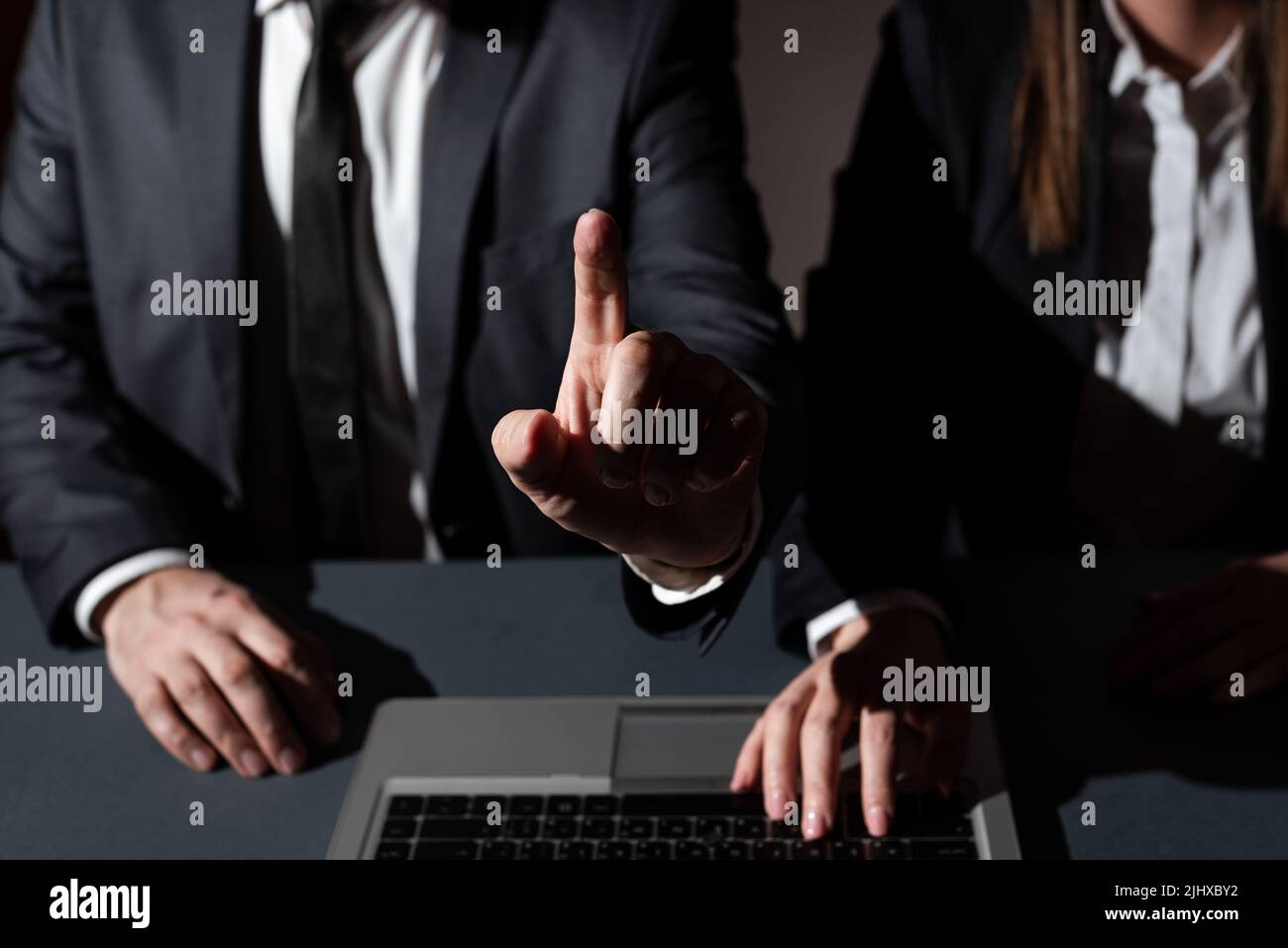 Sitting Woman On Desk With Lap Top And Man Pointing With One Finger On ...
