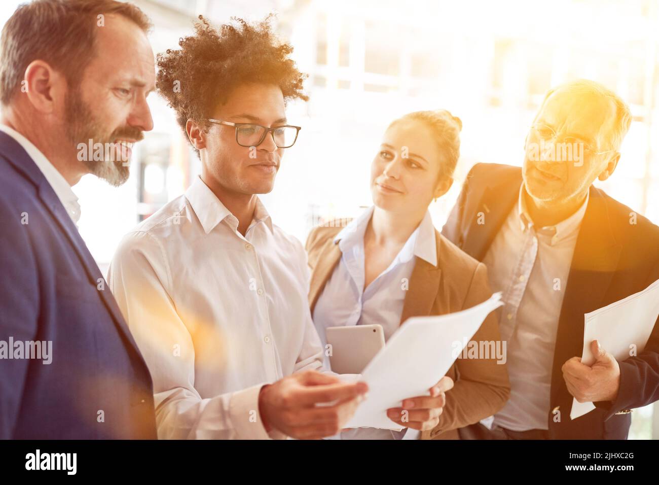 Multicultural business team collaborating in the office Stock Photo - Alamy