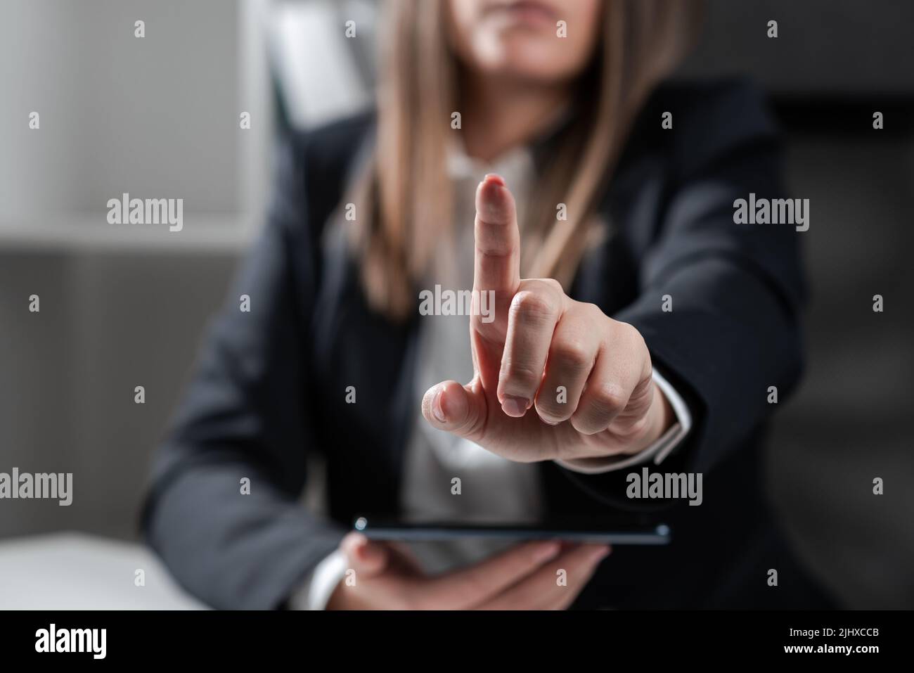 Young businesswoman holding index finger hi-res stock photography and ...