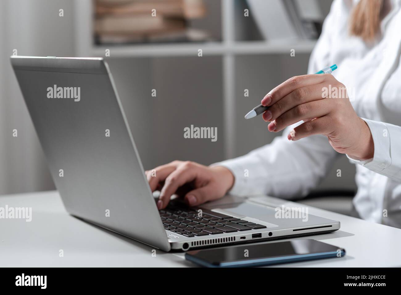 Businesswoman Typing Recent Updates On Lap Top Keyboard On Desk With ...