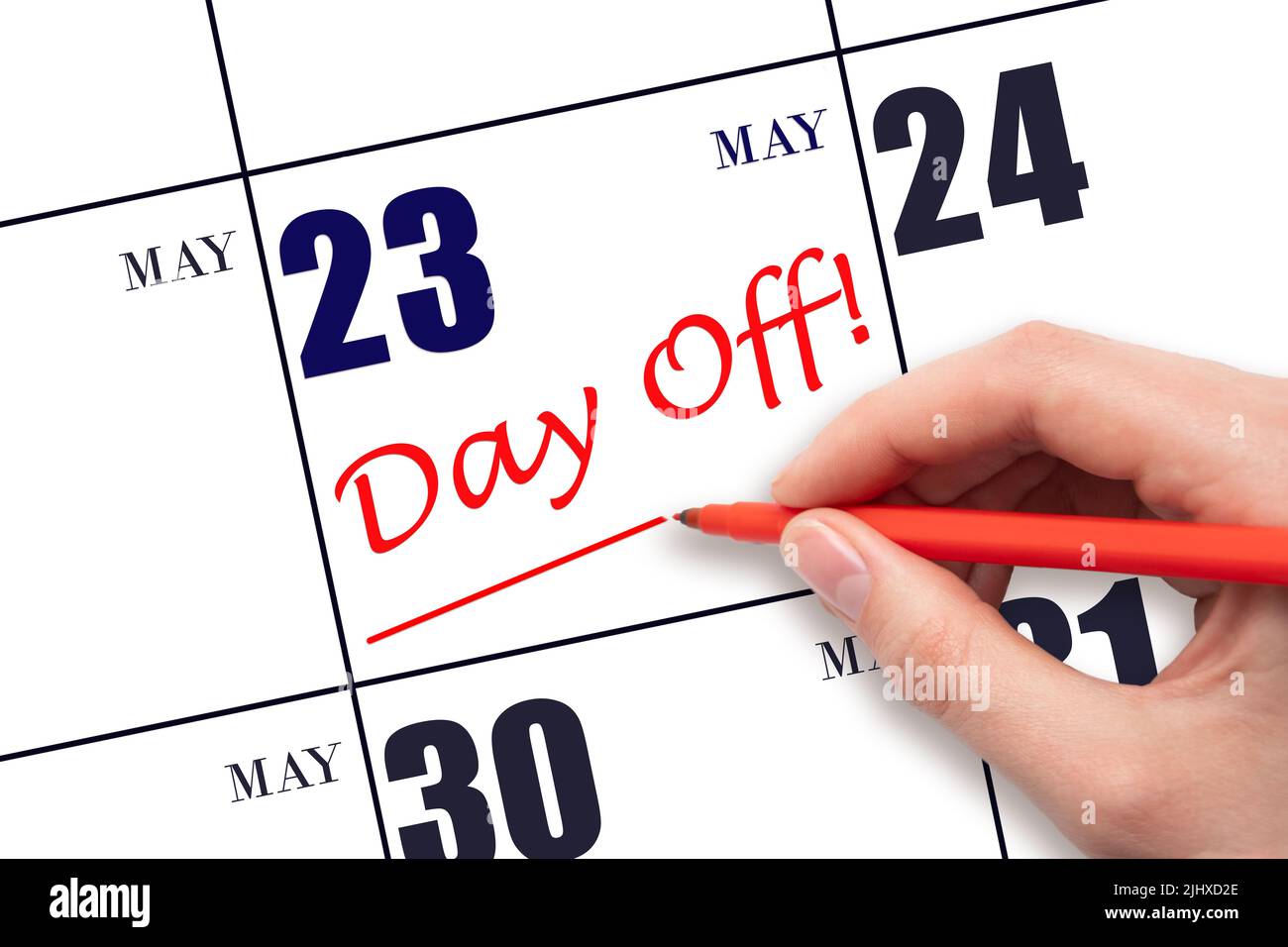 23rd day of May. Hand writing text DAY OFF and drawing a line on ...