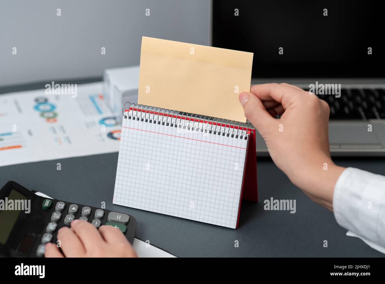 Businesswoman Holding Note With Current Message On Desk With Notebook ...
