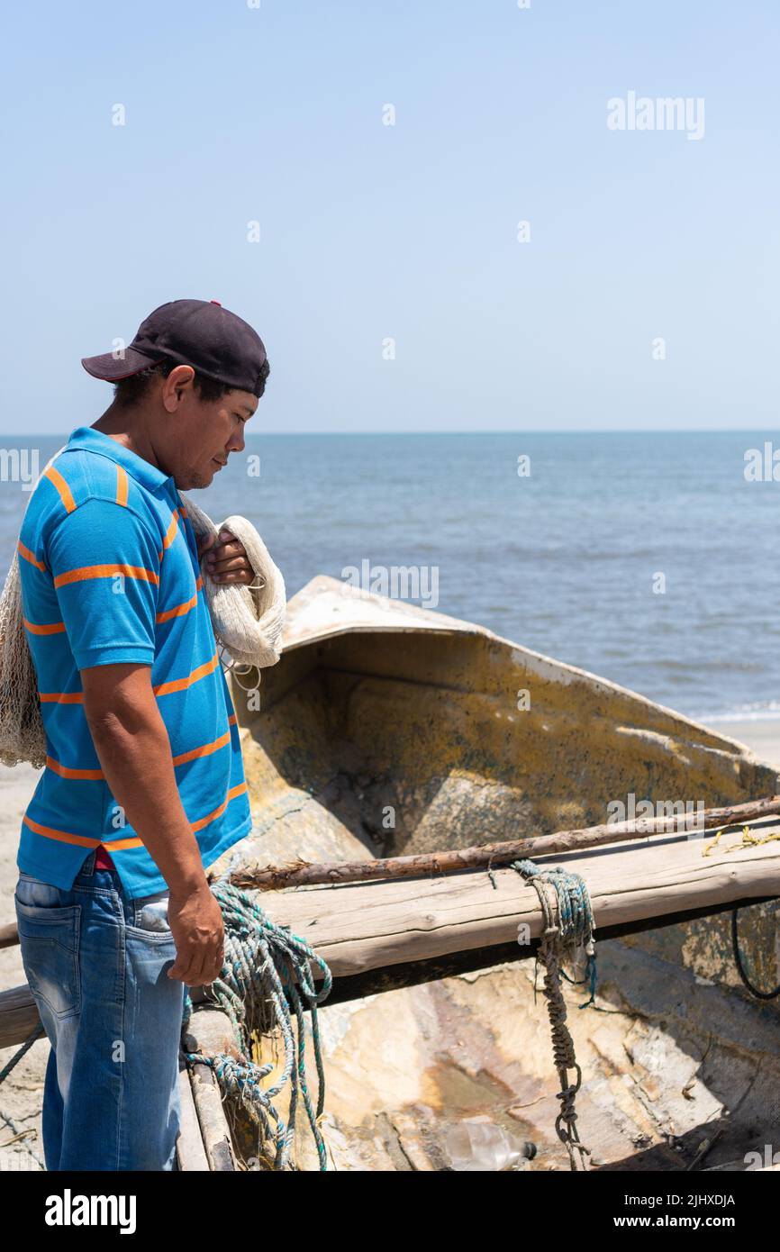 Fisherman with fishing net getting ready to go to the sea Stock Photo ...