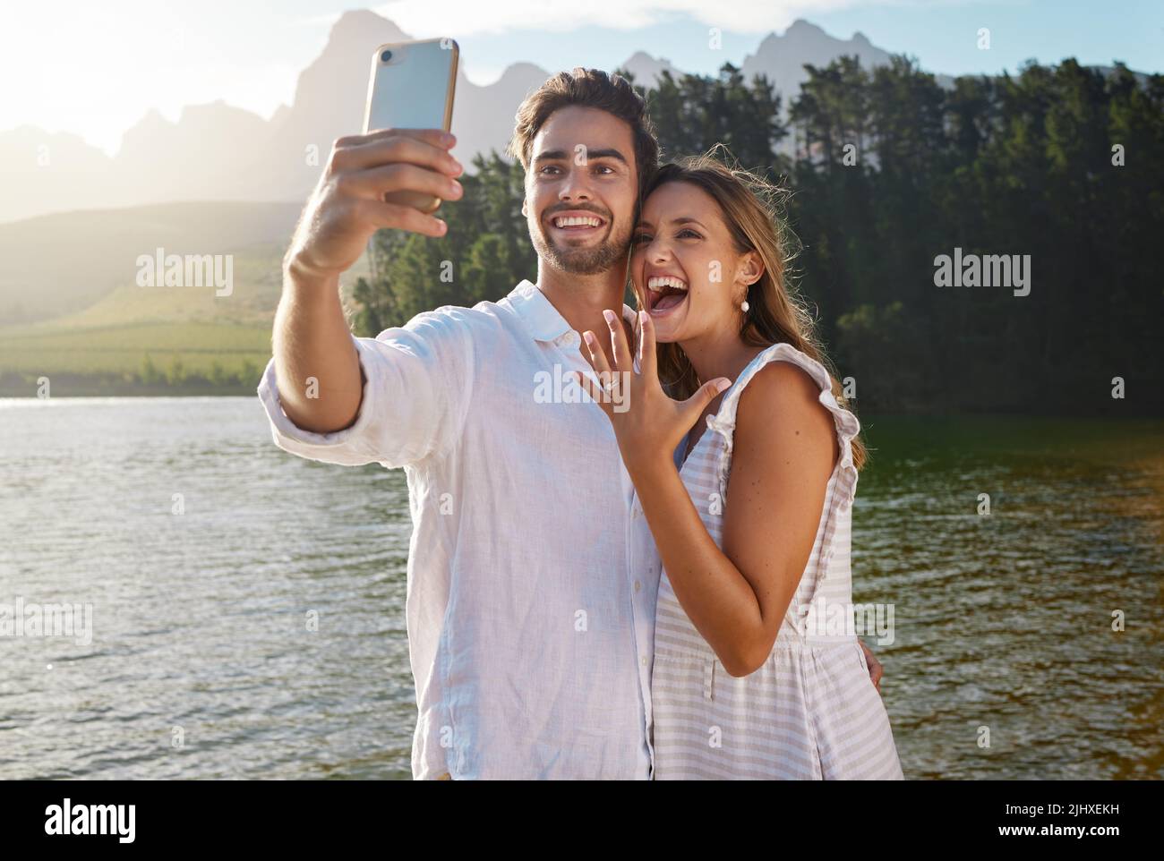 Weve got a surprise. a young couple taking a selfie after getting ...