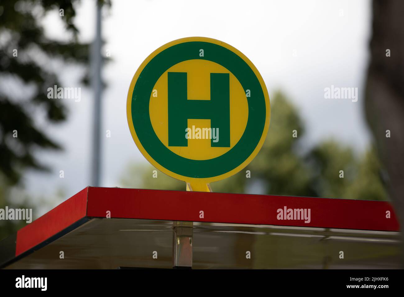bus stop sign at station next to street Stock Photo - Alamy