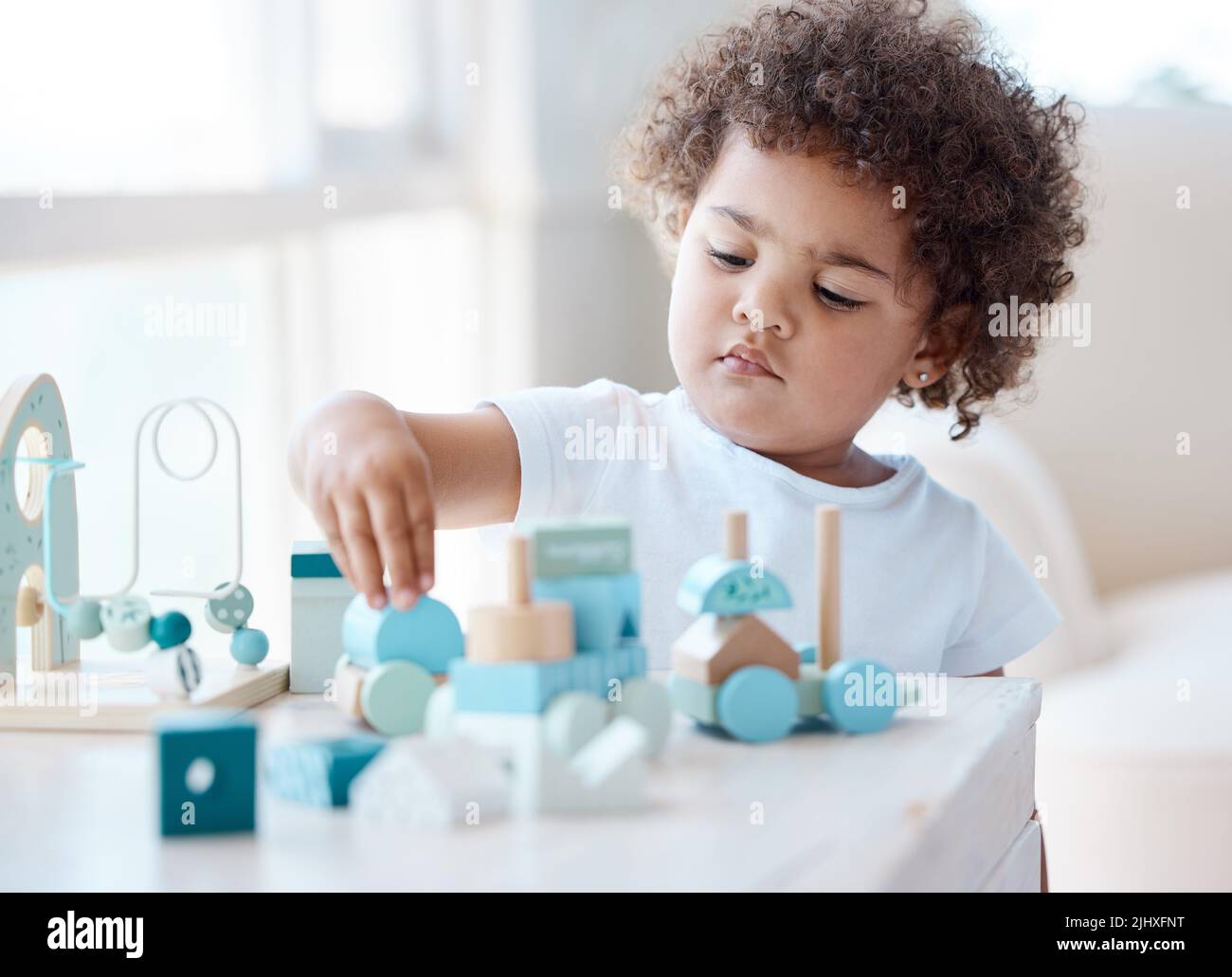 Building something new. a little girl playing with a toy at home Stock ...
