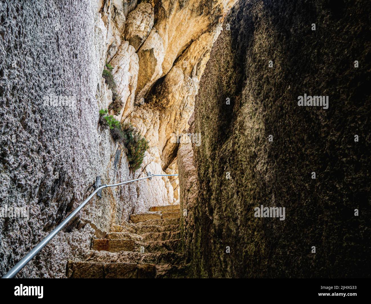 A view of stony staircases going up surrounded by stony walls in cave ...