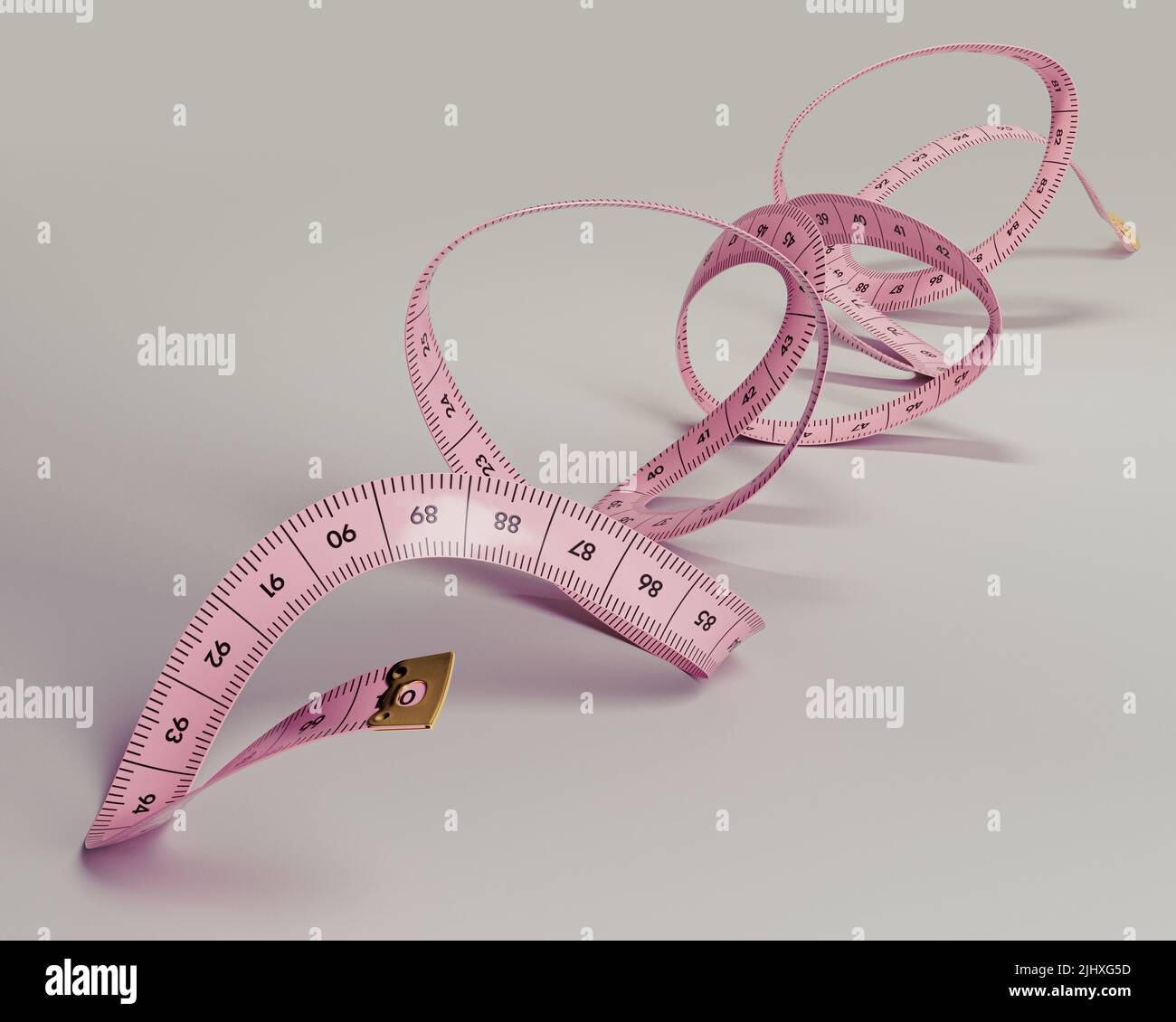 A pink curled and twisted up taylors measuring tape with measurements ...